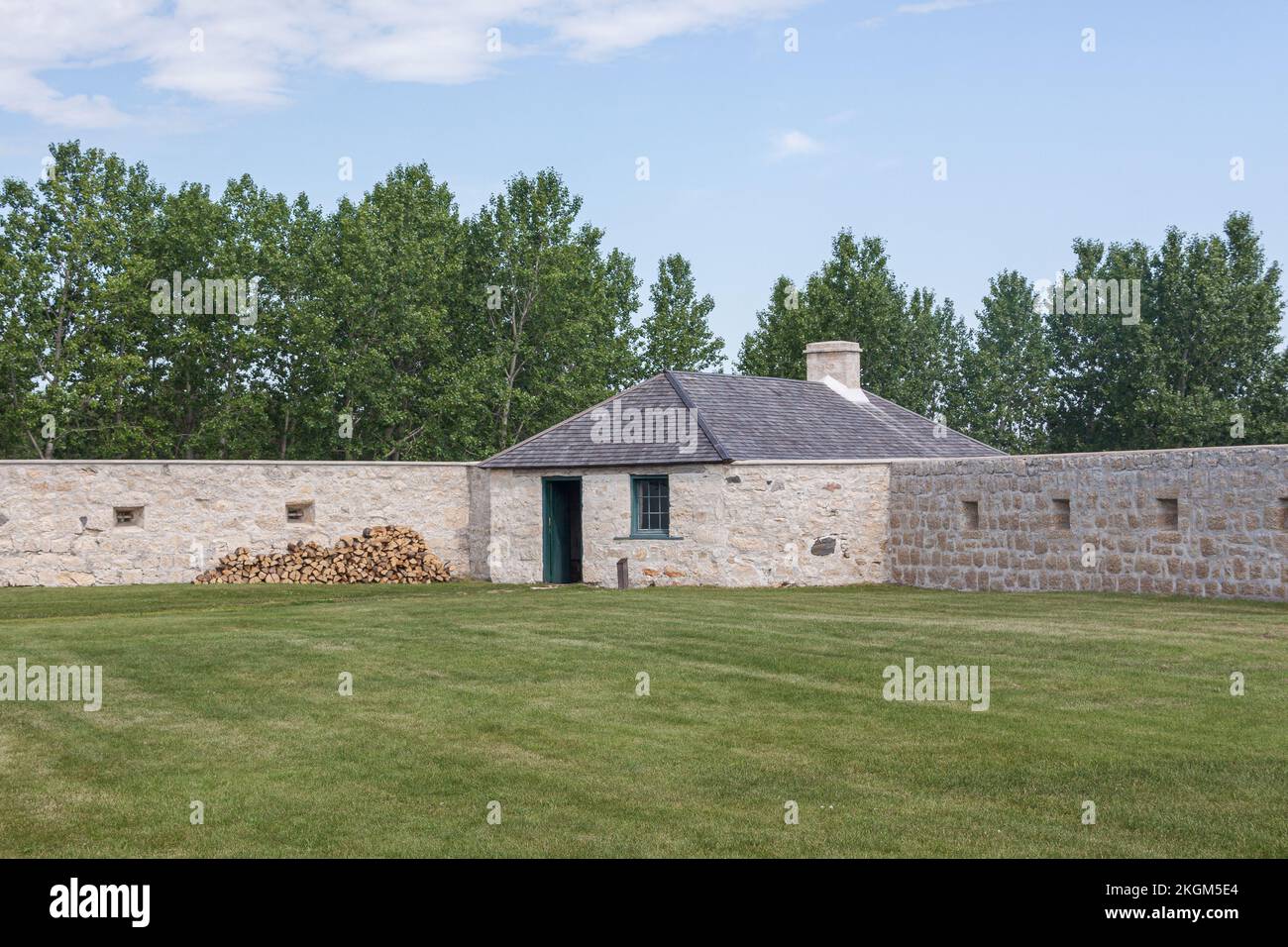A grass field next to the corner building of Lower Fort Garry in Canada ...