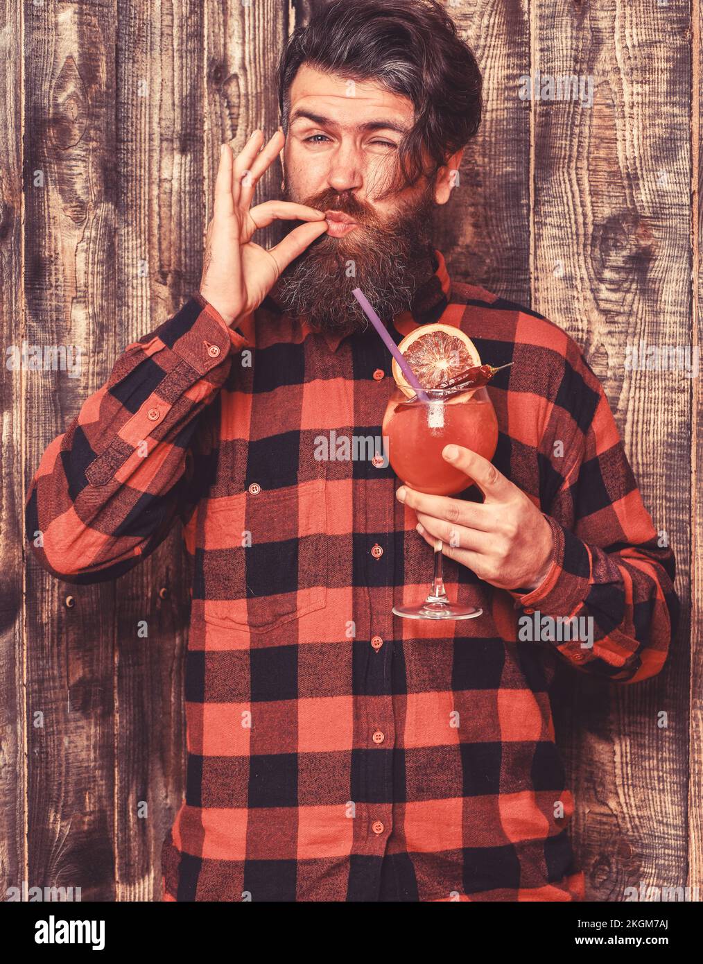 Man shows delicious gesture on wooden texture background Stock Photo ...