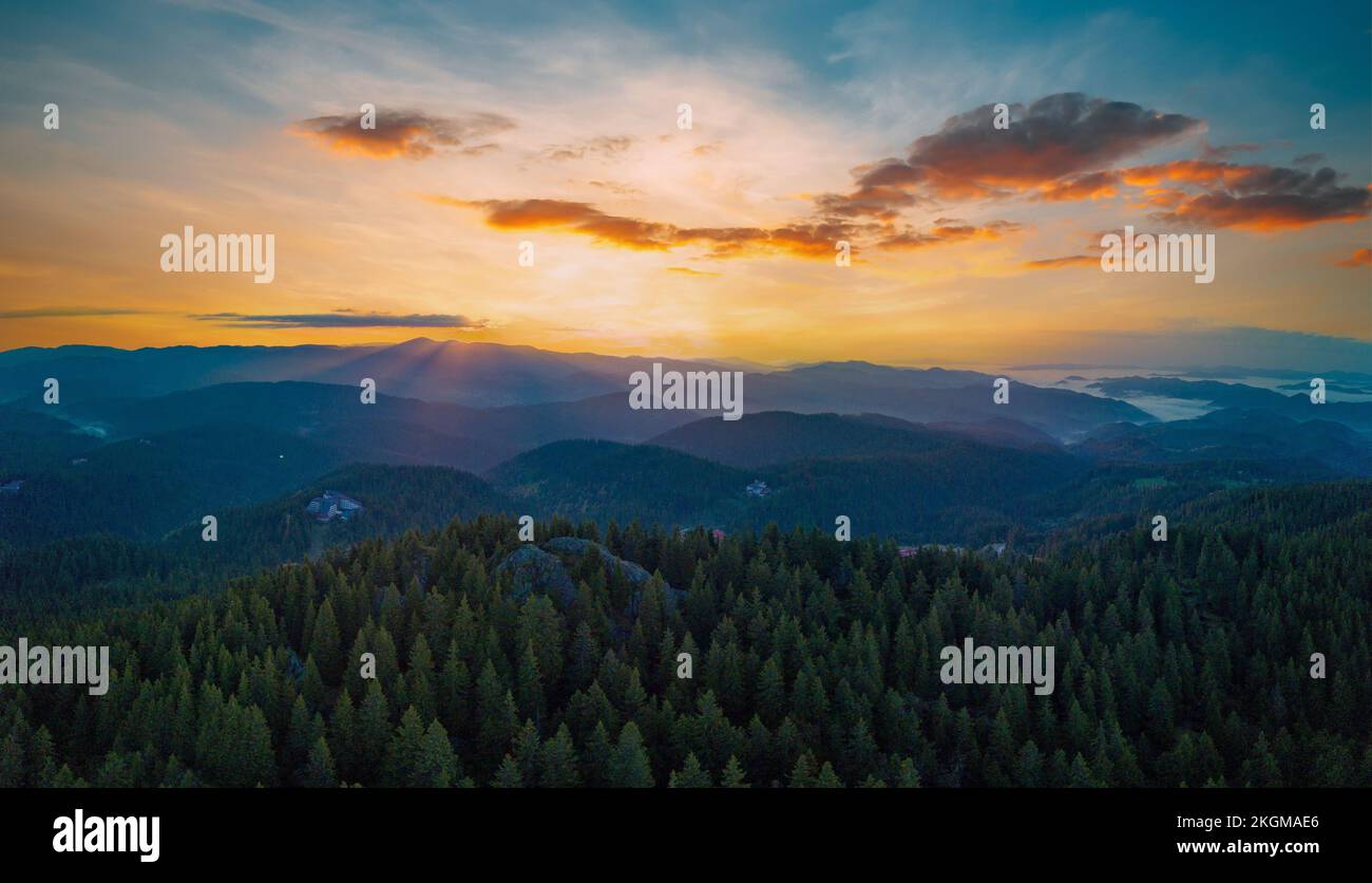 Valley of Balkan mountains with fog, sunny clouds and forests. Village ...