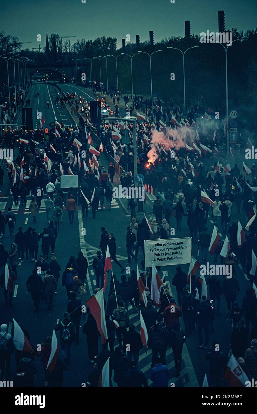 A vertical of people marching with Polish flags on the Independence day ...