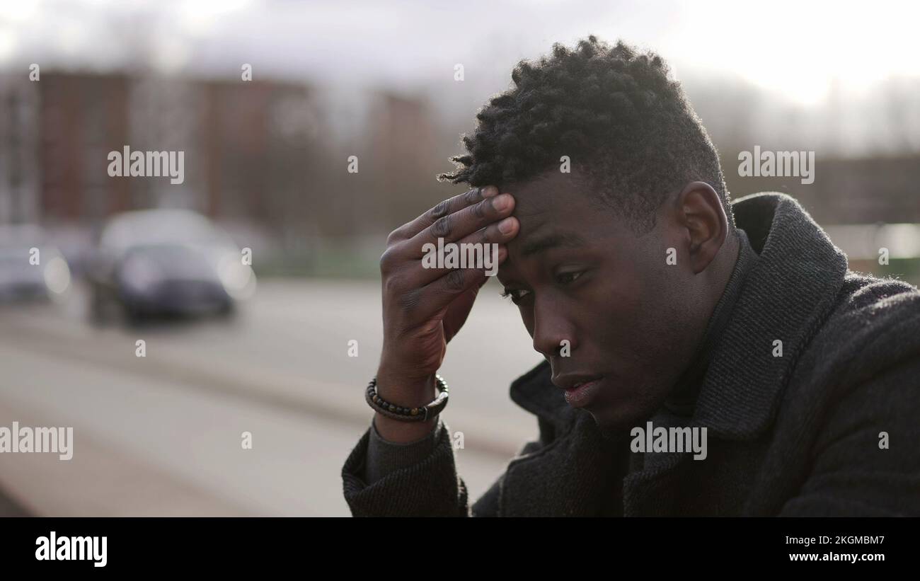 Troubled black African man feeling anxious and worry Stock Photo - Alamy