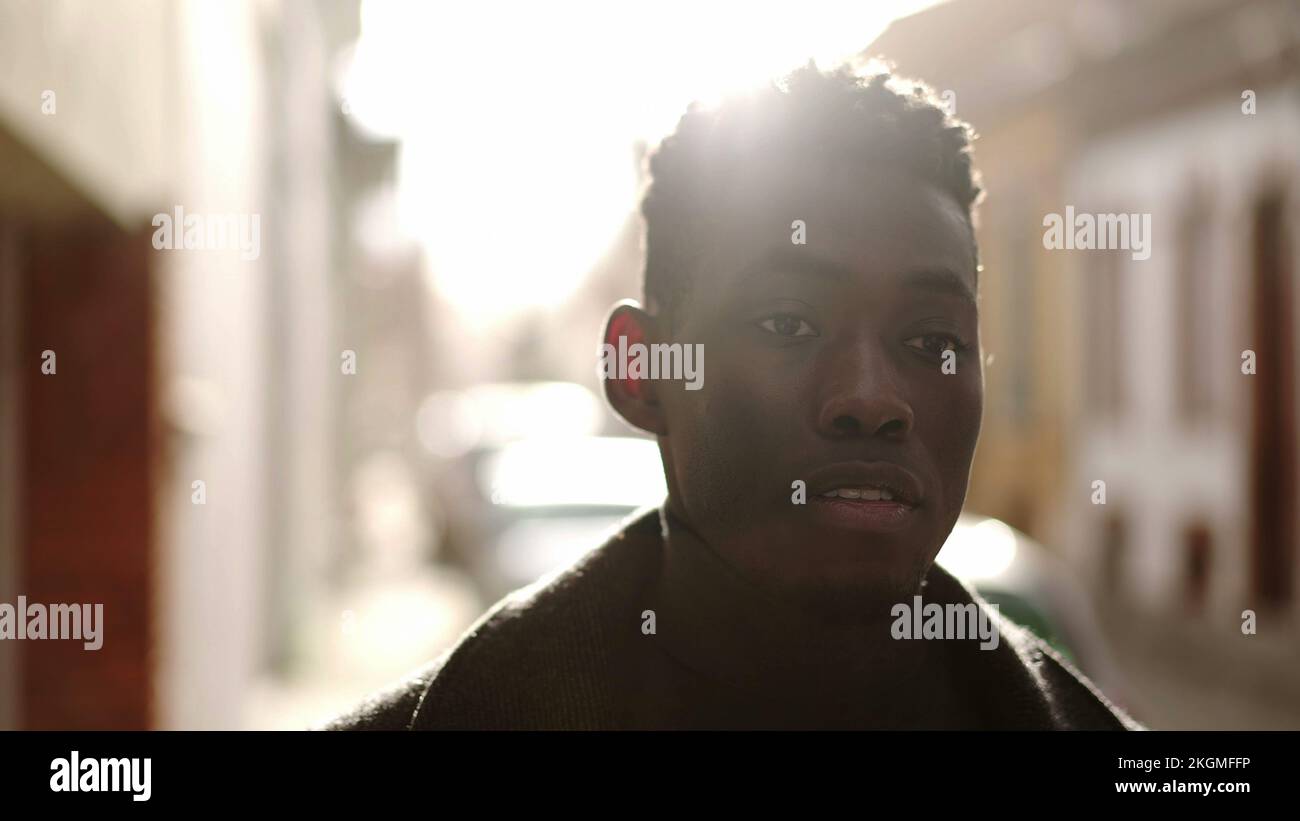 Young black man walking forward in urban city at sunlight Stock Photo ...