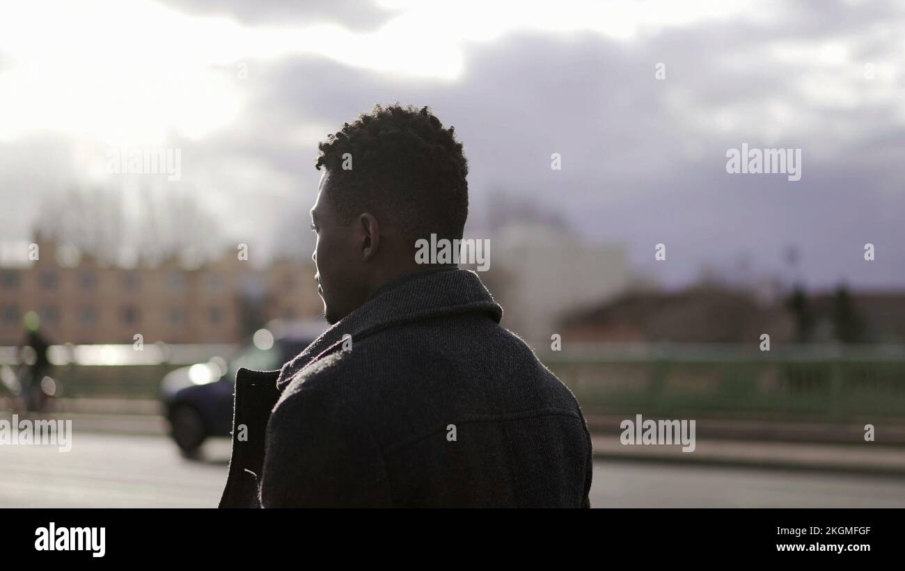 Young black man walking forward in urban city at sunlight Stock Photo ...