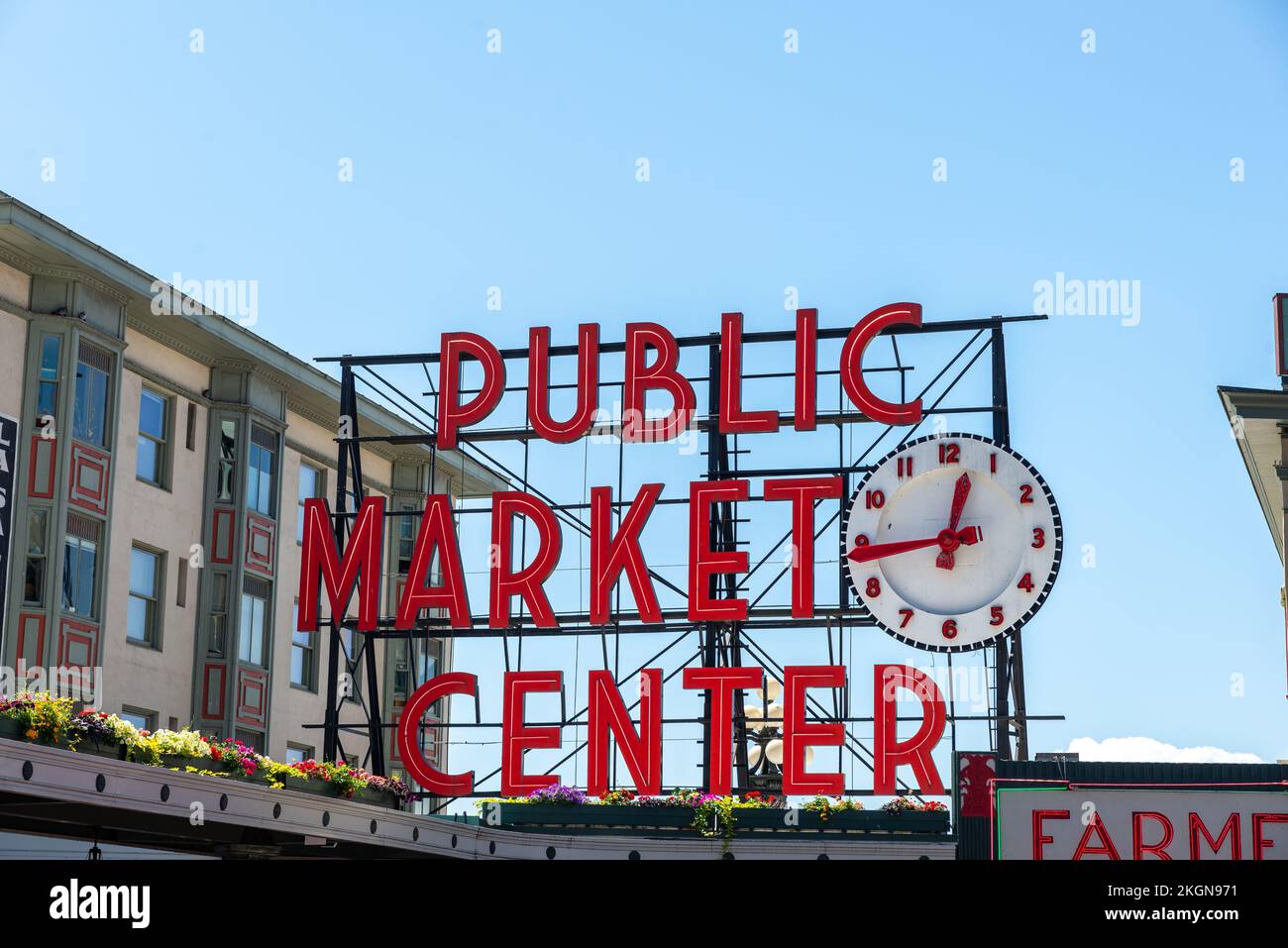 The red Public market sign with a clock before the blue skyline in ...