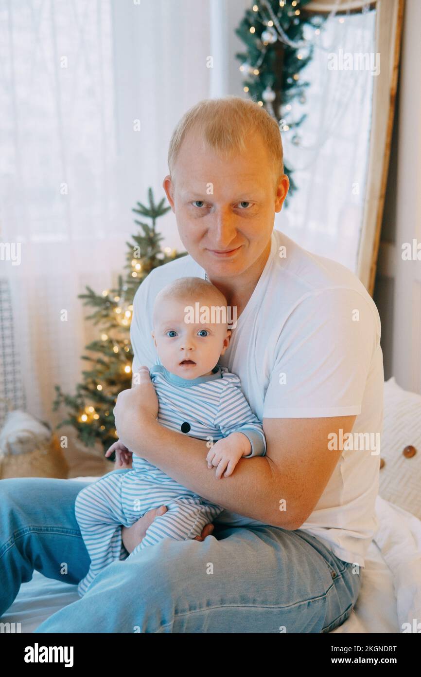 Dad and son at home on the bed. The concept of family relations and the ...