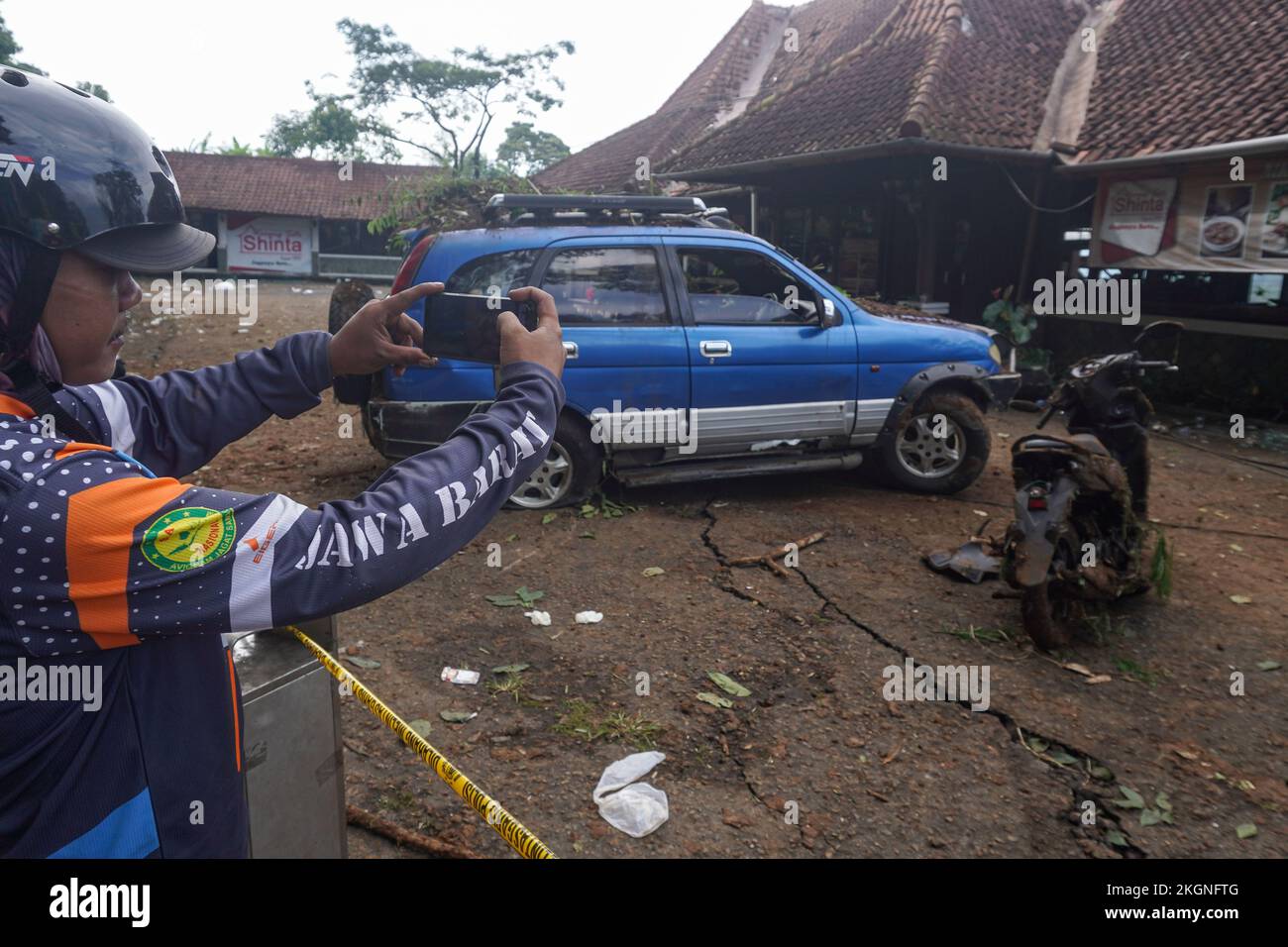Cianjur, West Java, Indonesia. 22nd Nov, 2022. A man takes a picture of ...
