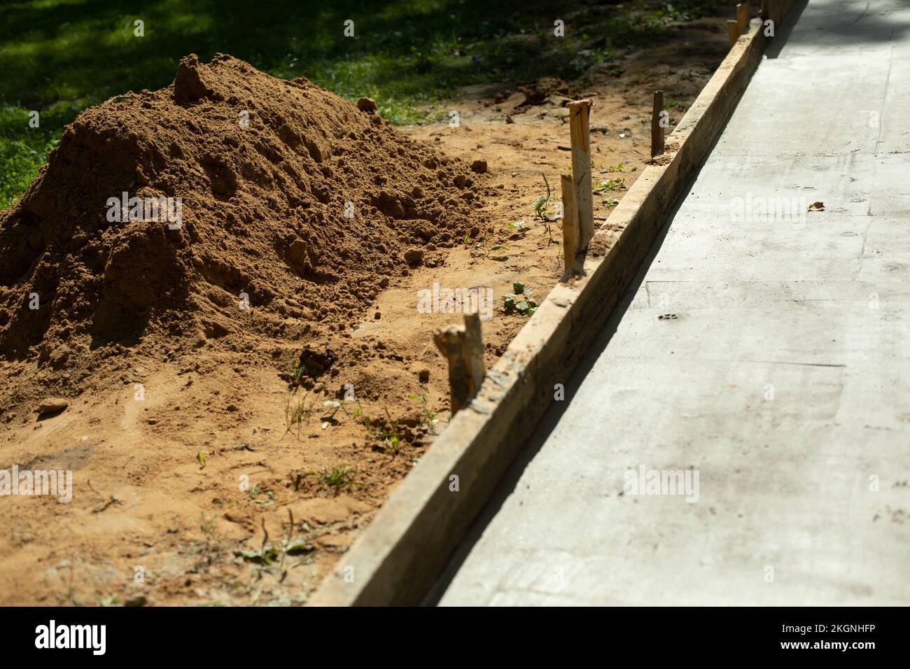 Construction work. Formwork with cement. Pouring foundation. Wooden ...
