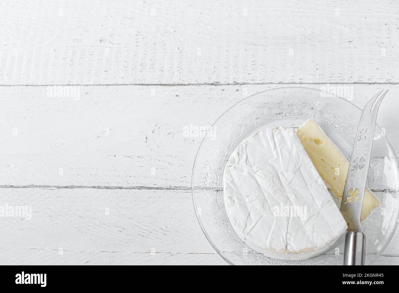Soft cheese - french brie isolated on white background with knife. Side ...