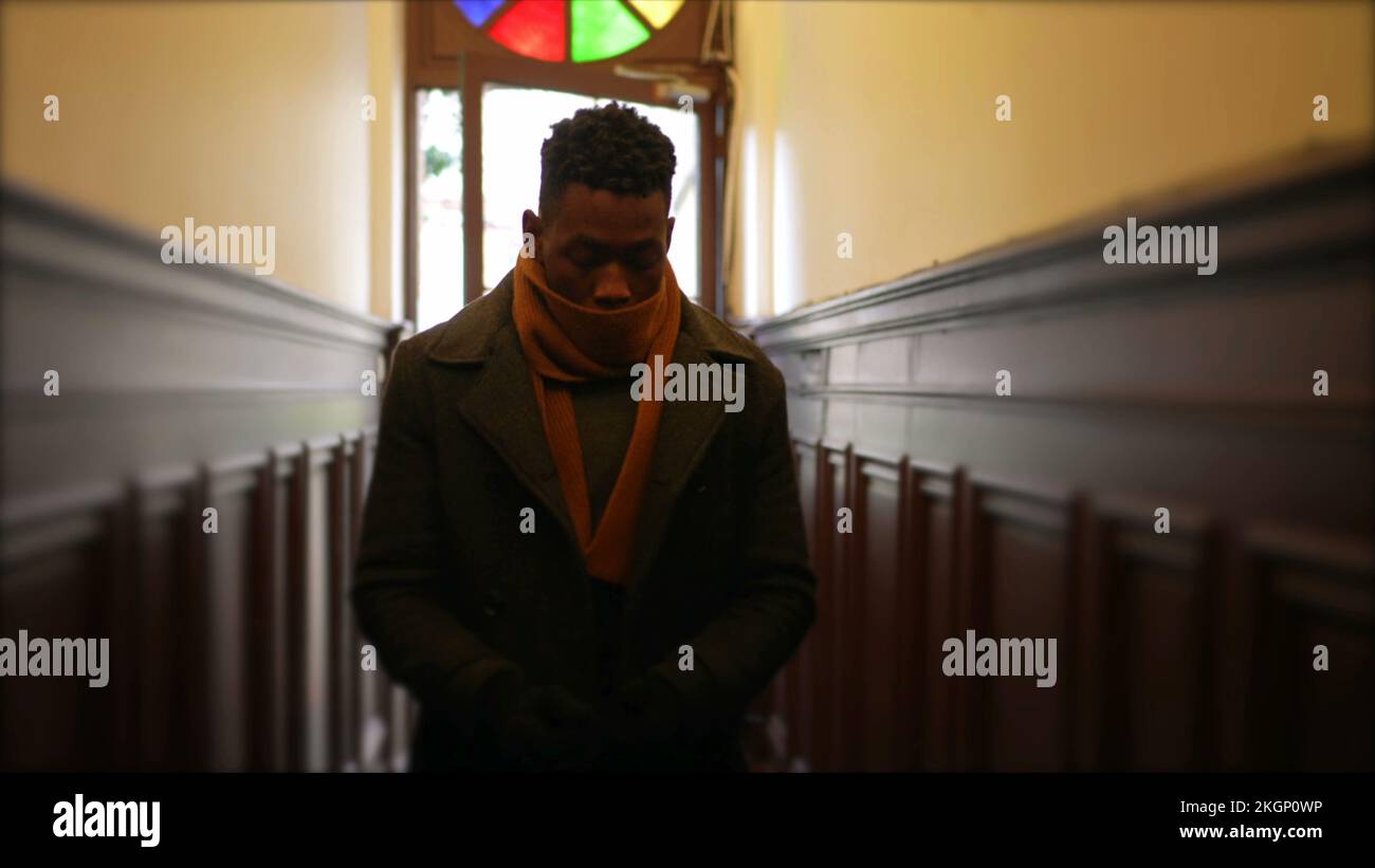 Young man opening front door walking through corridor stepping outside ...