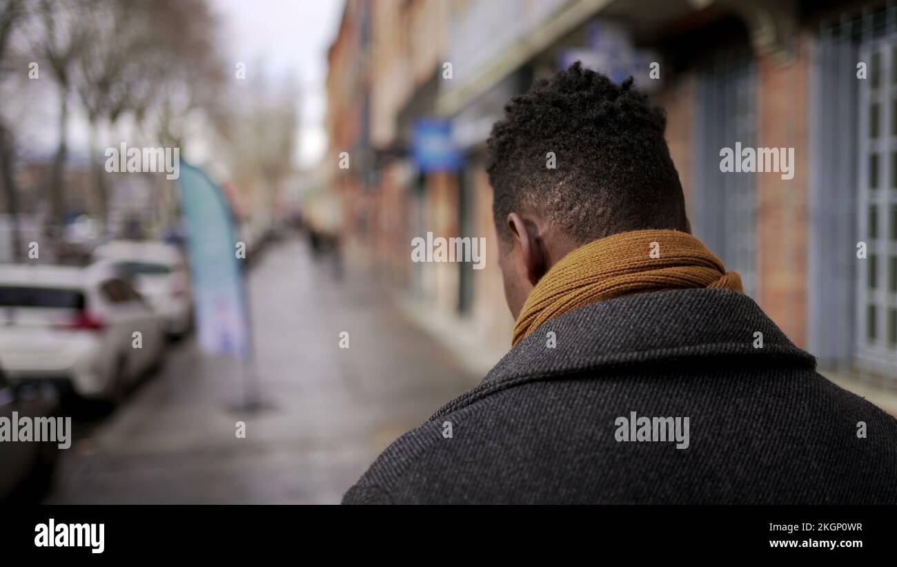 Young elegant black African man walking outside in city sidewalk Stock ...