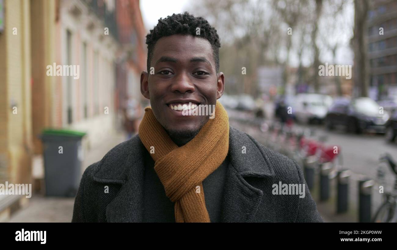 Young happy black African man walking outside Stock Photo - Alamy