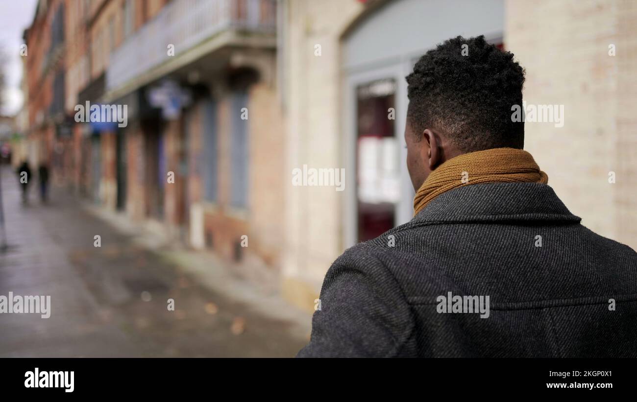 Young elegant black African man walking outside in city sidewalk Stock ...