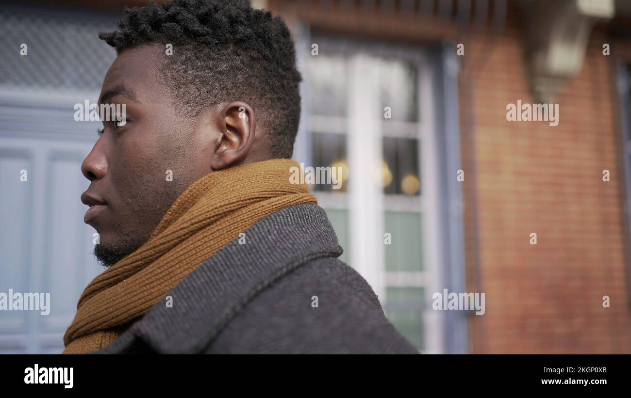 Young elegant black African man walking outside in city sidewalk Stock ...