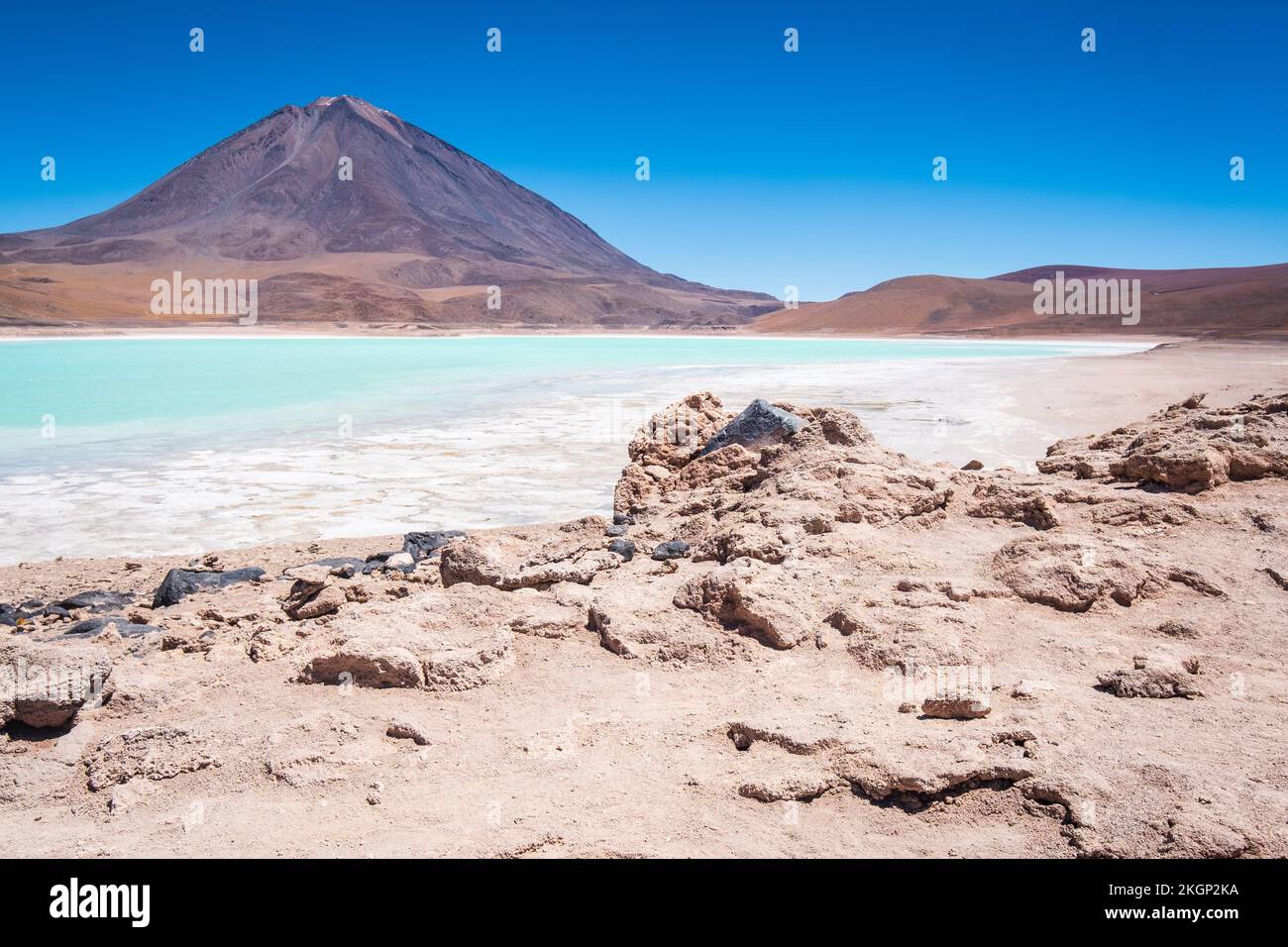 Volcanic rocks at the Laguna Verde (Green Lagoon) with the Licancabur ...