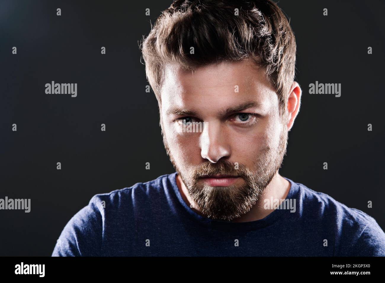 Portrait of sad man with beard in front of black background Stock Photo ...