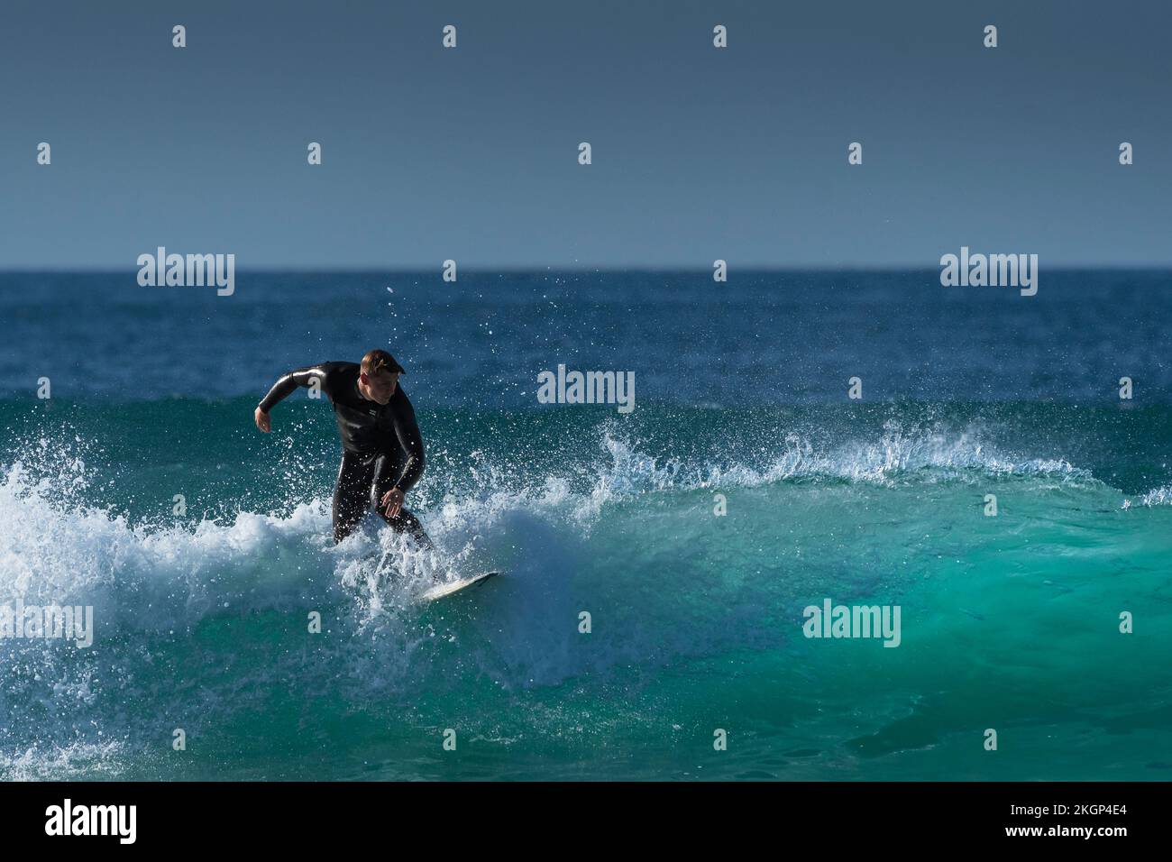 Spectaular surfing action as a male surfer rides a wave at Fistral in ...