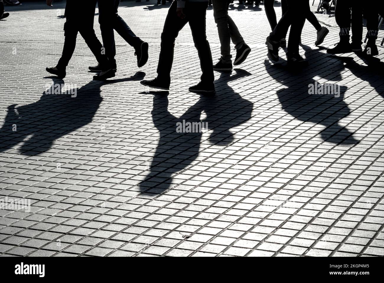 Shadows of people walking on pavement Stock Photo - Alamy