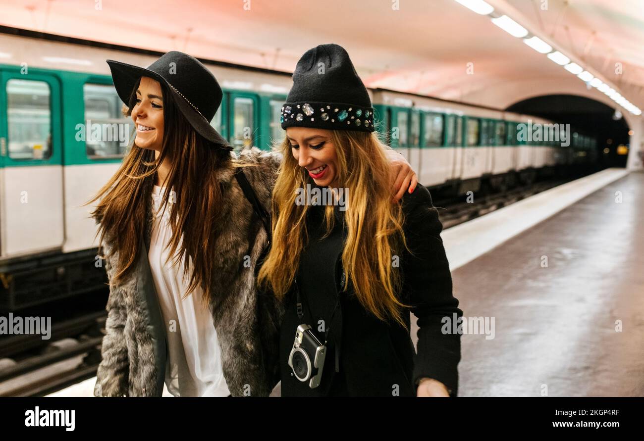 Paris, France, two happy friends at underground station platform Stock ...