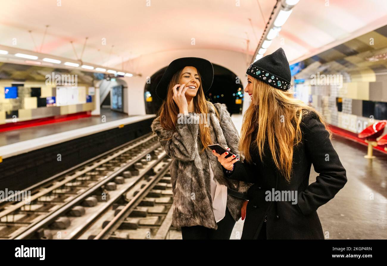 Paris, France, laughing tourists waiting at underground station ...