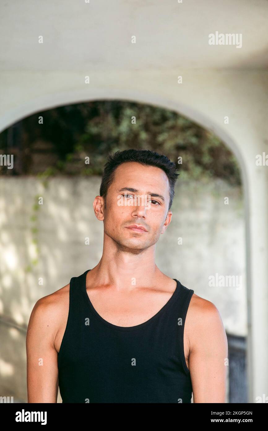 Male dancer standing in front of arch Stock Photo - Alamy
