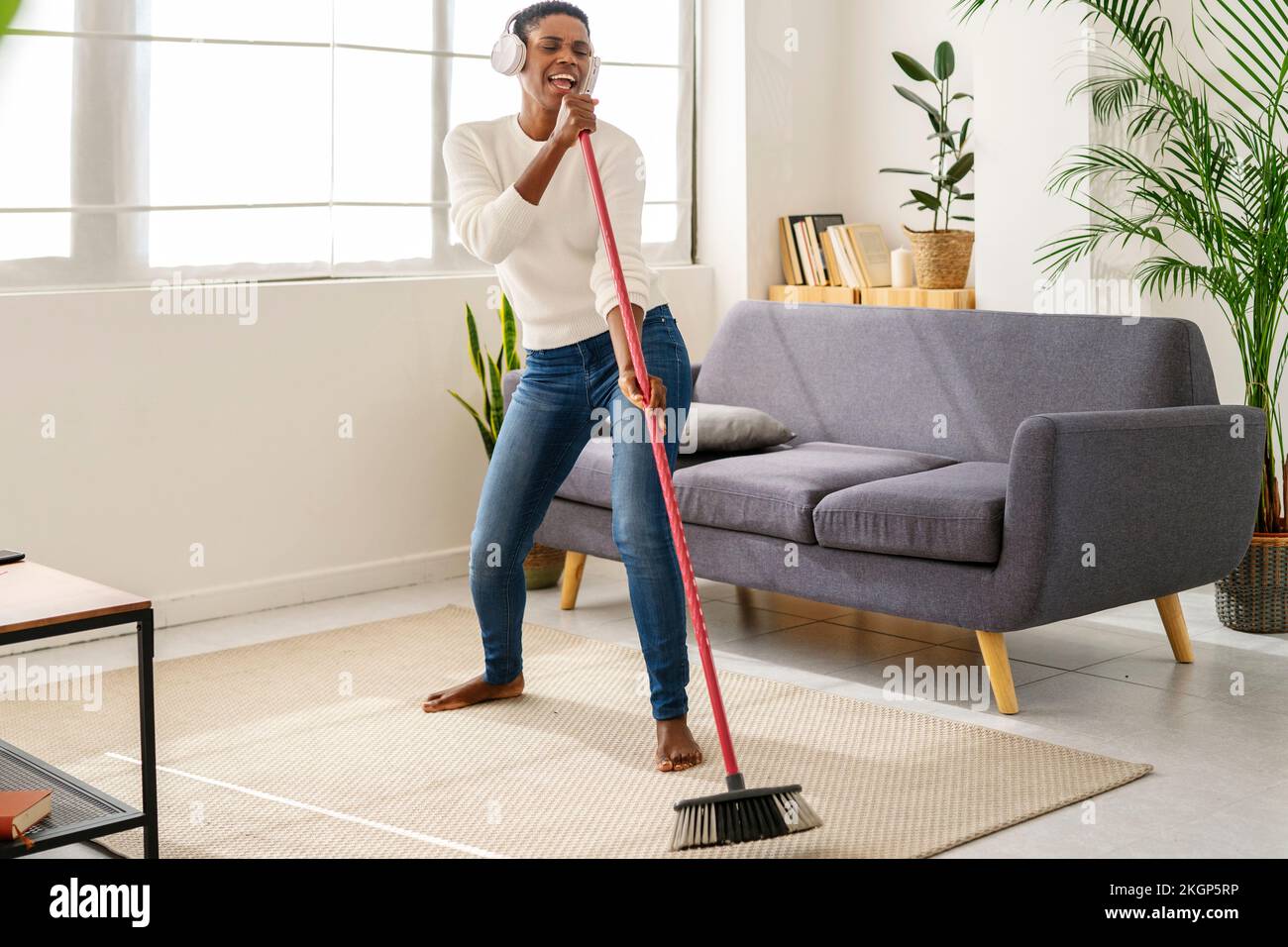 Woman sweeping floor hi-res stock photography and images - Alamy