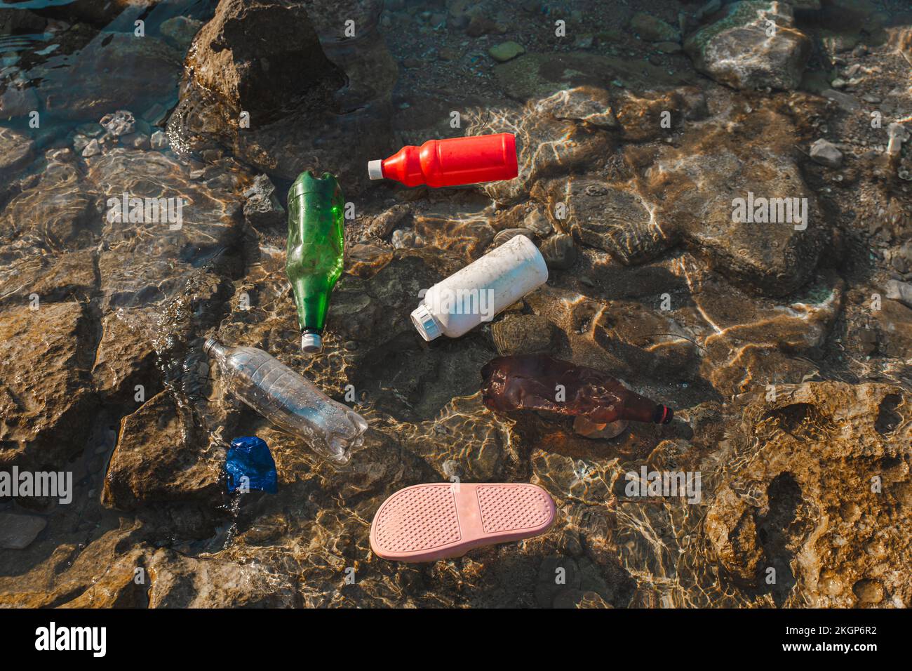 Empty plastic bottles and slippers floating on water Stock Photo - Alamy