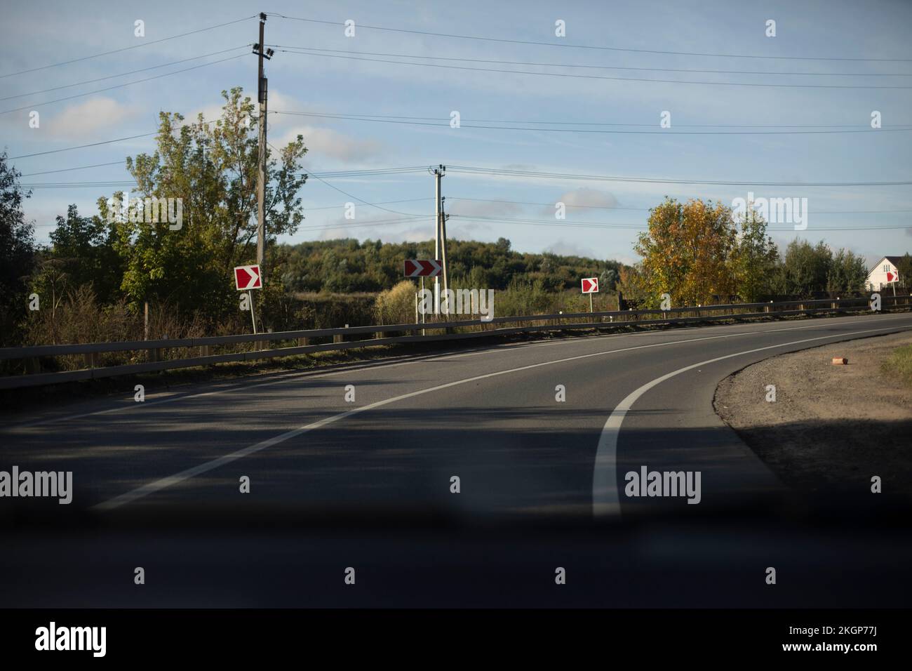 Sharp turn of road. Bending of road with markings. Red turn signs ...