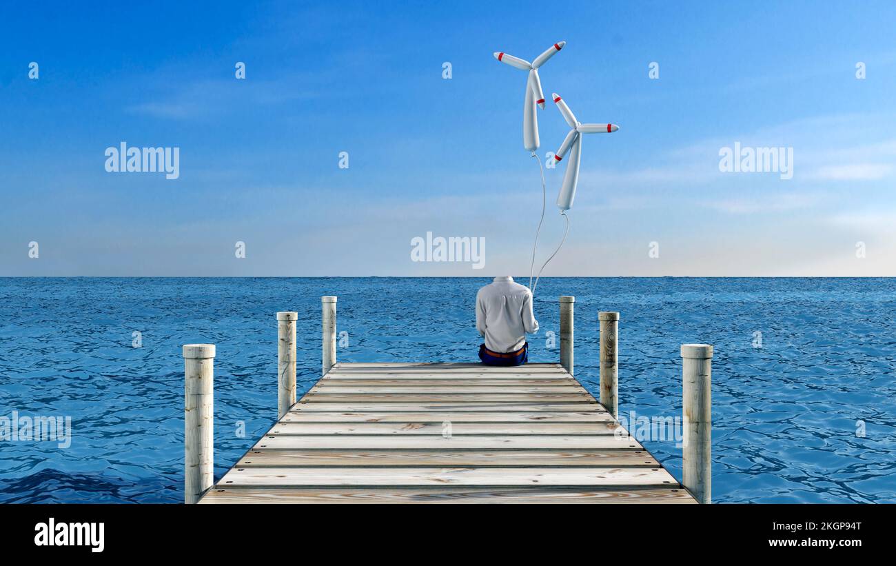 Invisible person sitting at edge of jetty with wind turbine shaped ...