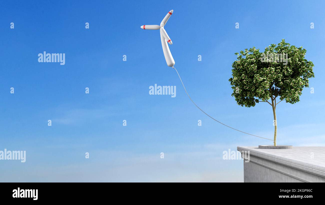 Wind turbine shaped balloon tied to single tree growing on rooftop ...