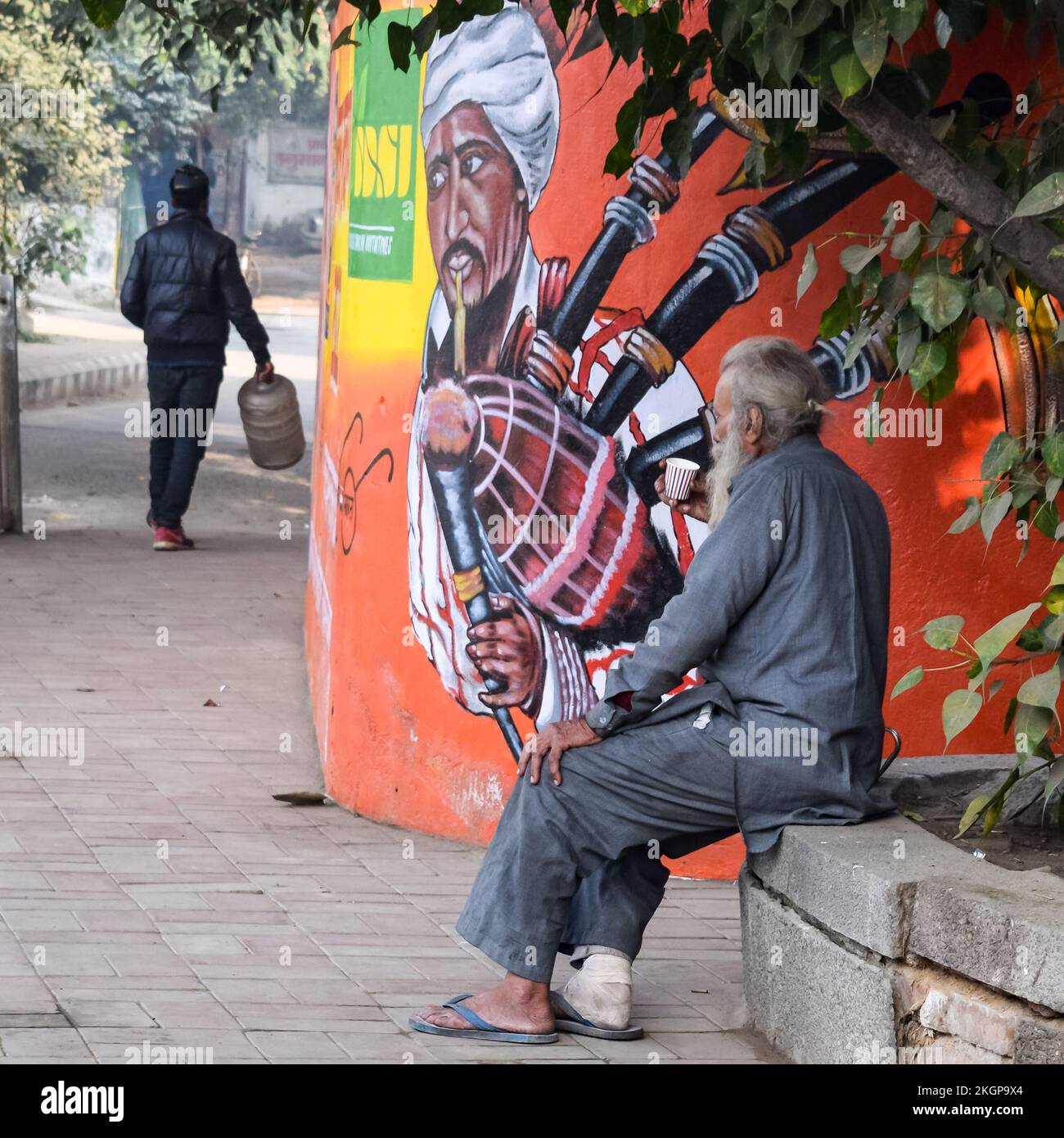 New Delhi, India - December 25, 2021 - Old poor man drinking tea during ...