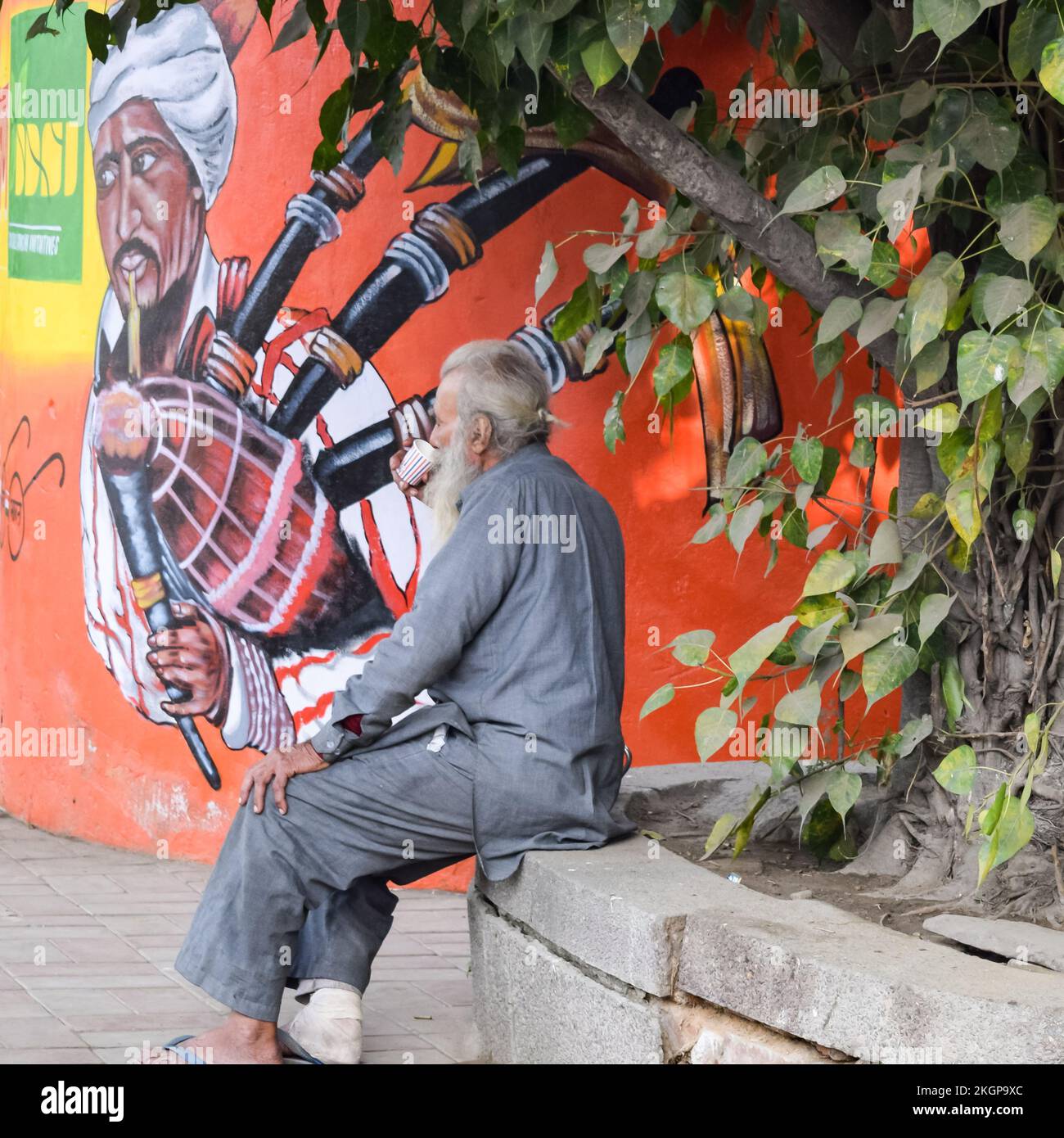 New Delhi, India - December 25, 2021 - Old poor man drinking tea during ...