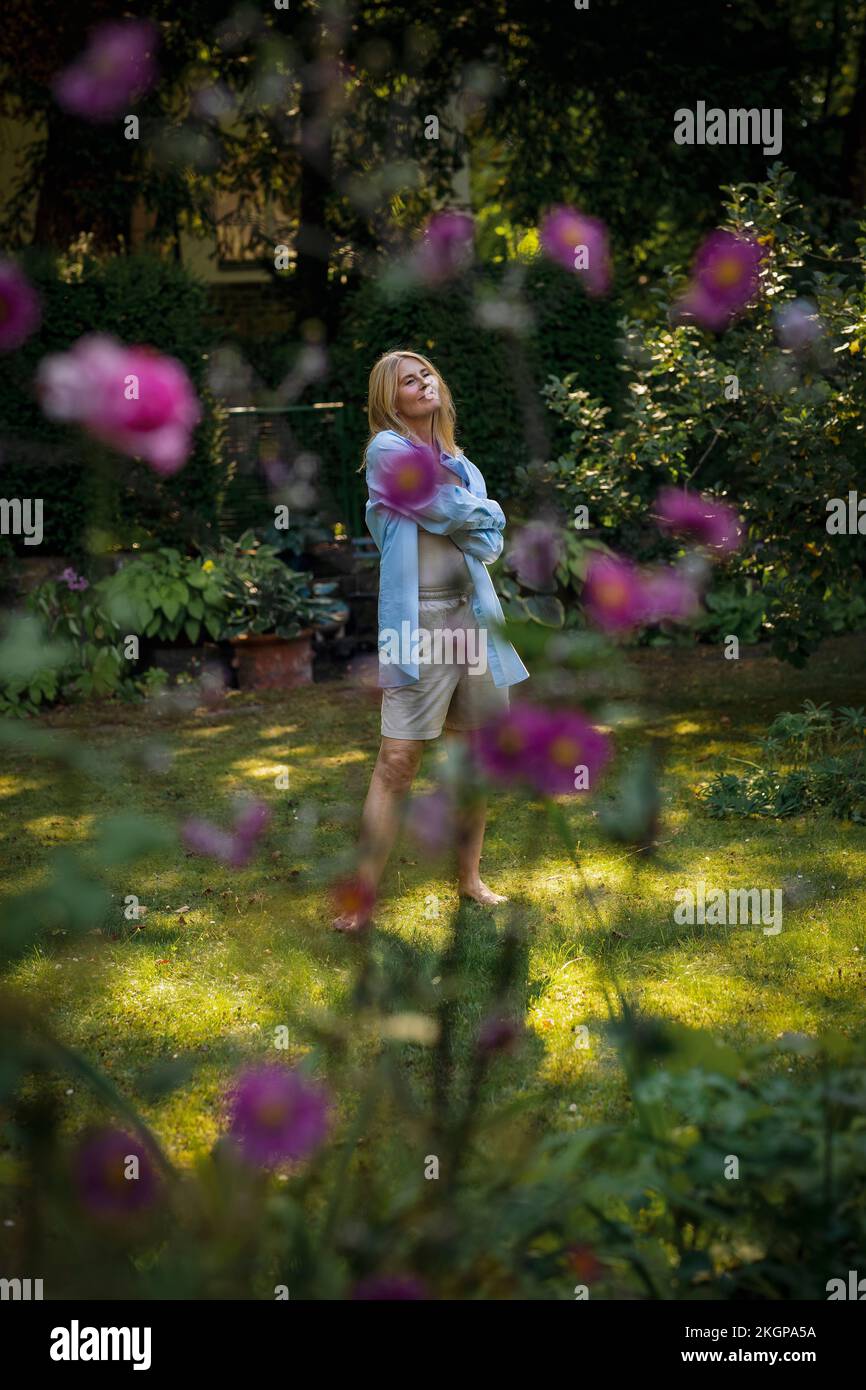 Woman hugging herself outdoors hi-res stock photography and images - Alamy