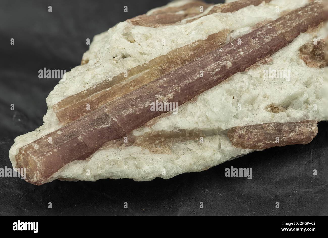 reddish tourmaline mineral sample on matrix on black background Stock ...