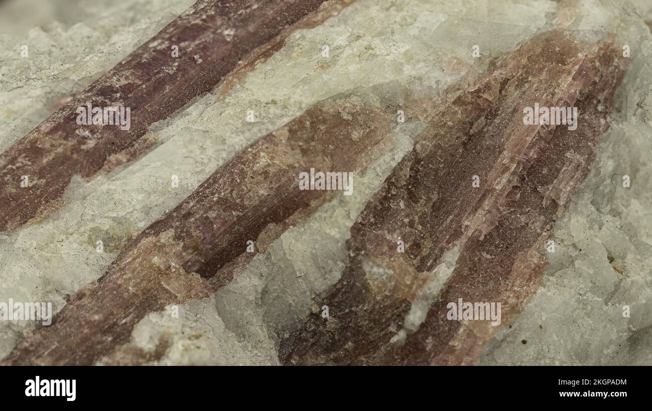 Reddish Tourmaline stone on matrix against Black Background Stock Photo ...