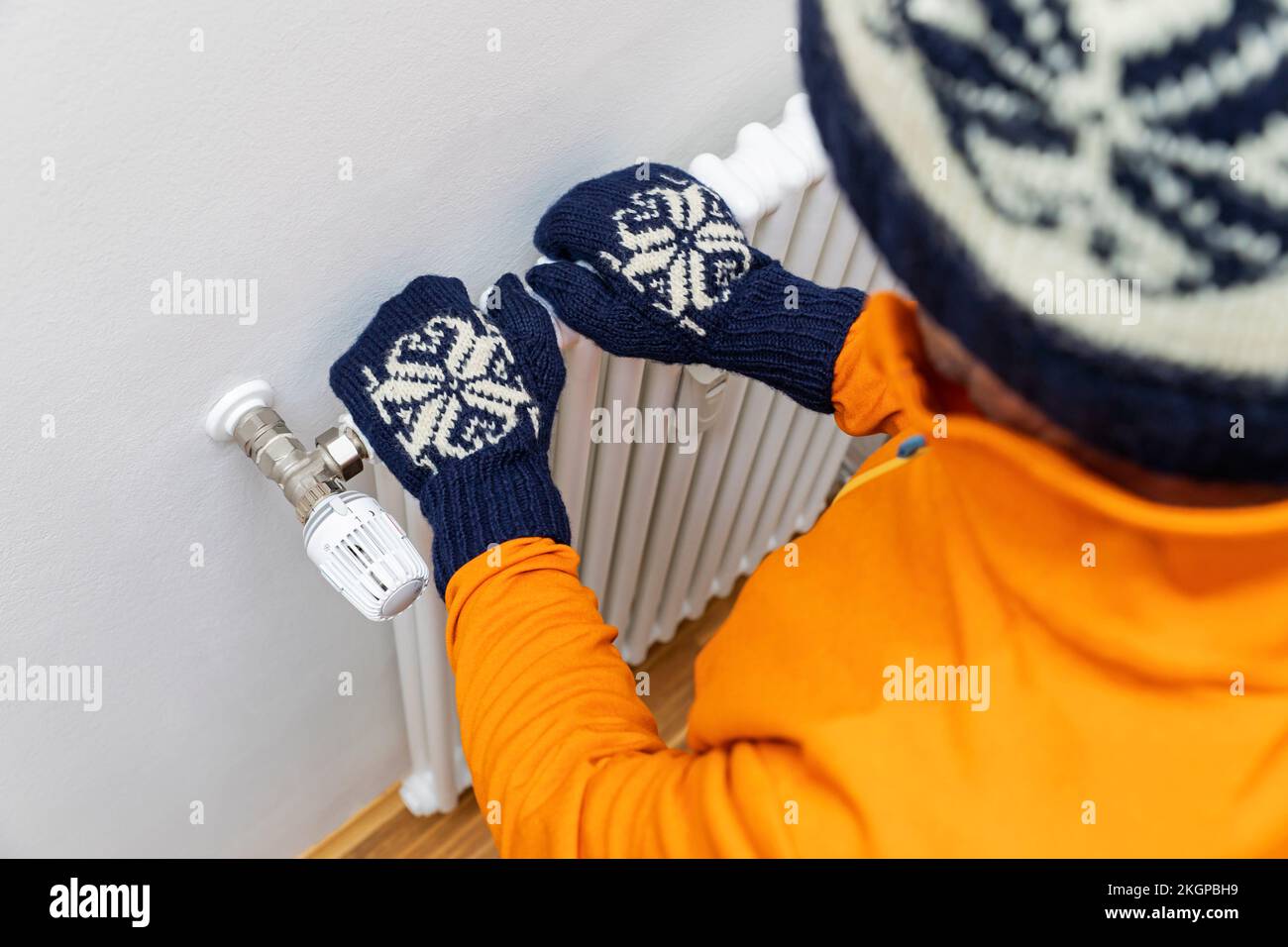 Senior man standing with hands on radiator Stock Photo - Alamy