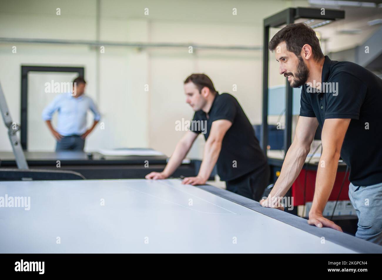 Professional worker printmaker technician operator works in printing ...