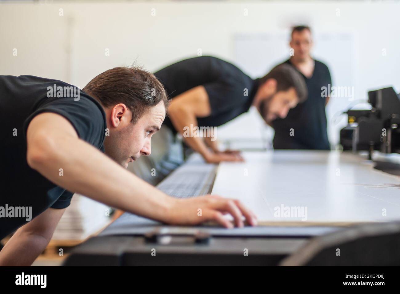 Professional worker printmaker technician operator works in printing ...