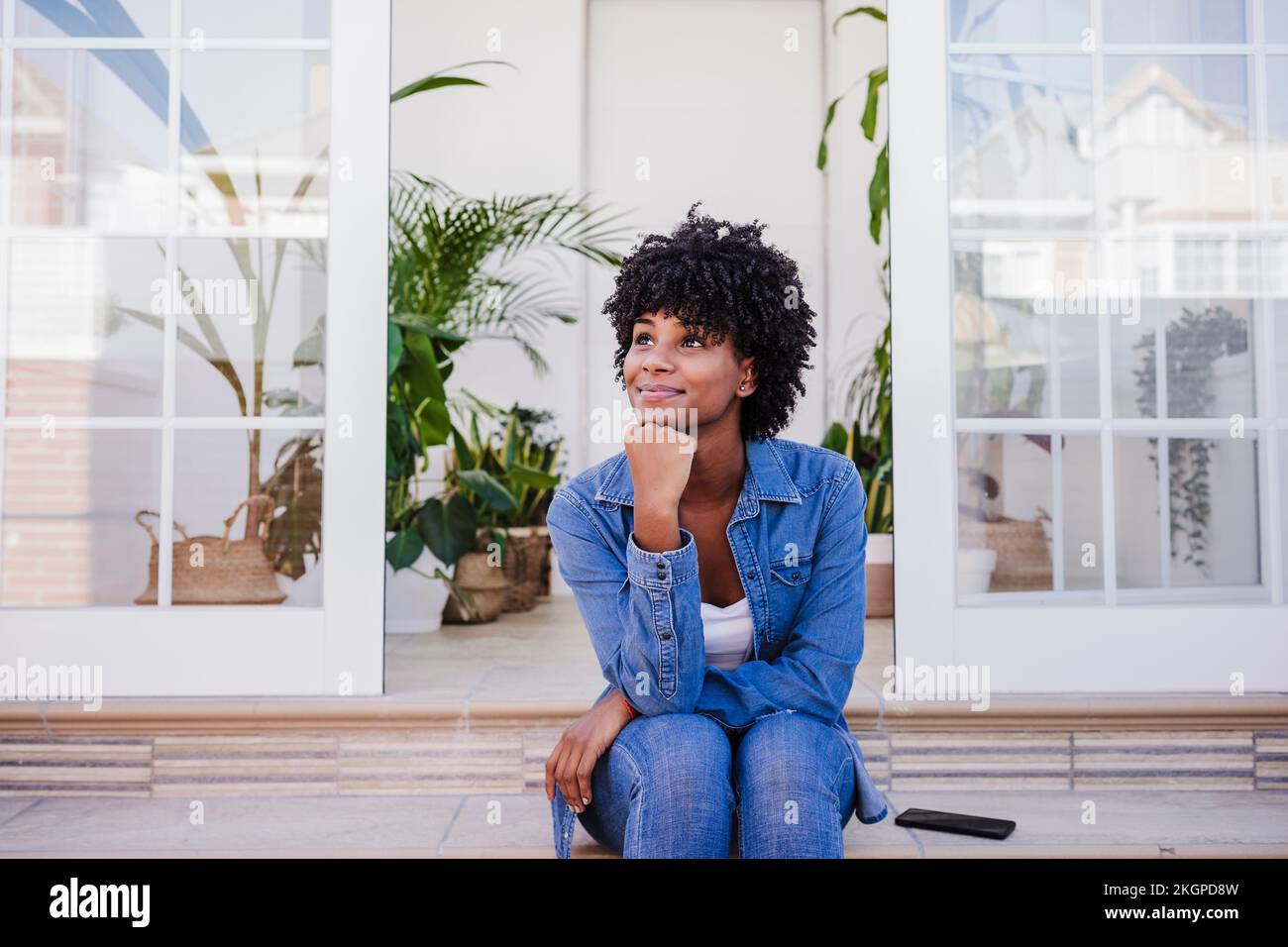 Young contemplative woman sitting in hi-res stock photography and ...