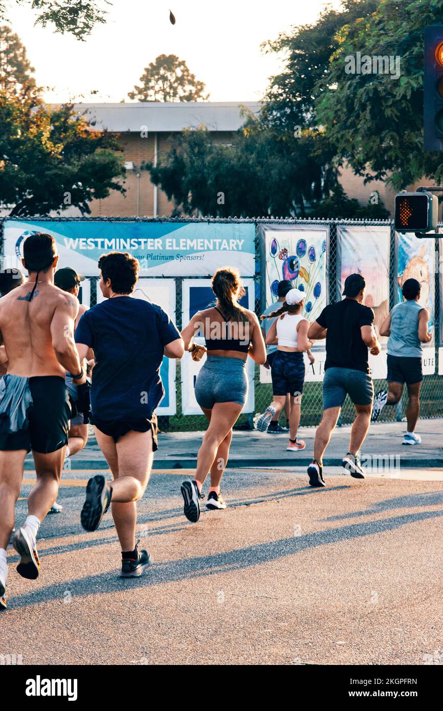 A vertical shot of people running in the street in LA, California Stock ...