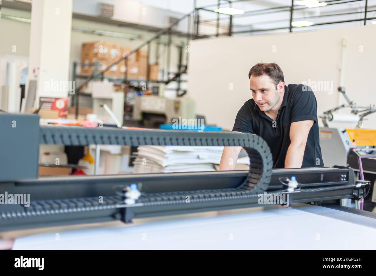 Professional worker printmaker technician operator works in printing ...