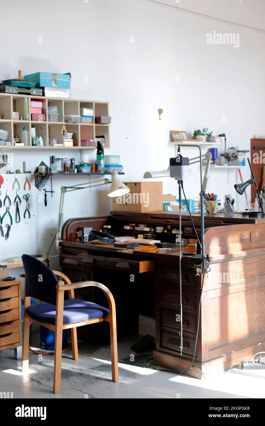Table and chair with work tools in jewelry workshop Stock Photo - Alamy