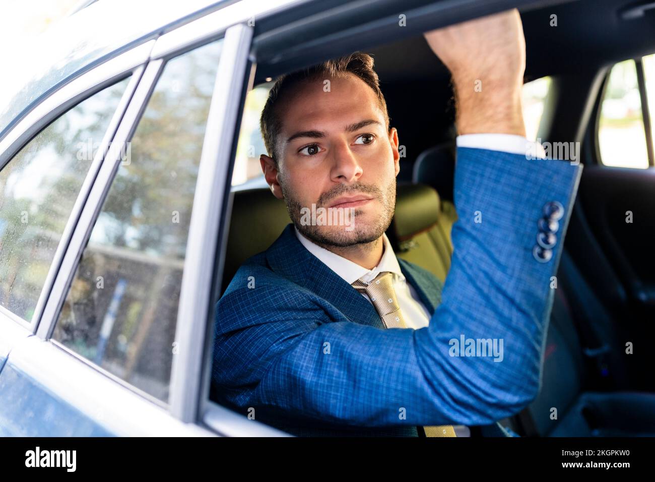 Thoughtful businessman looking out of taxi window Stock Photo - Alamy Thoughtful businessman looking out of taxi window Stock Photo - Alamy