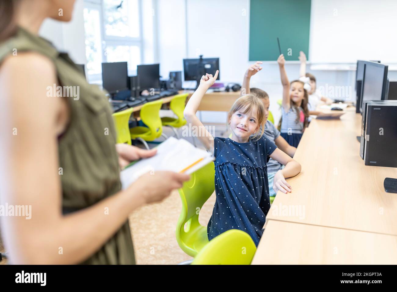 Children hand raised class hi-res stock photography and images - Alamy