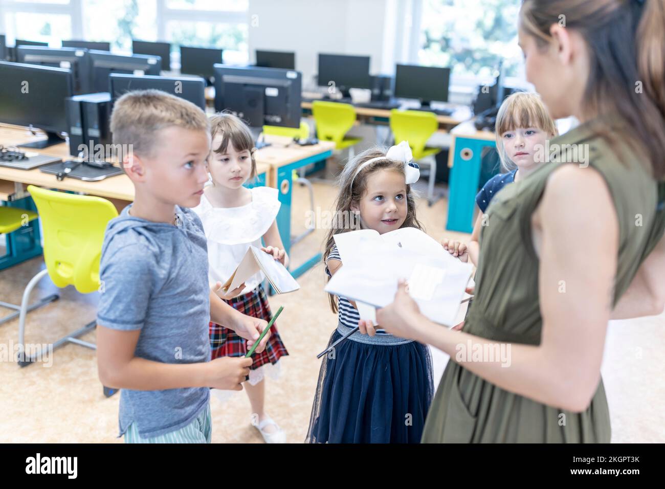 Students showing homework to teacher in classroom at school Stock Photo ...
