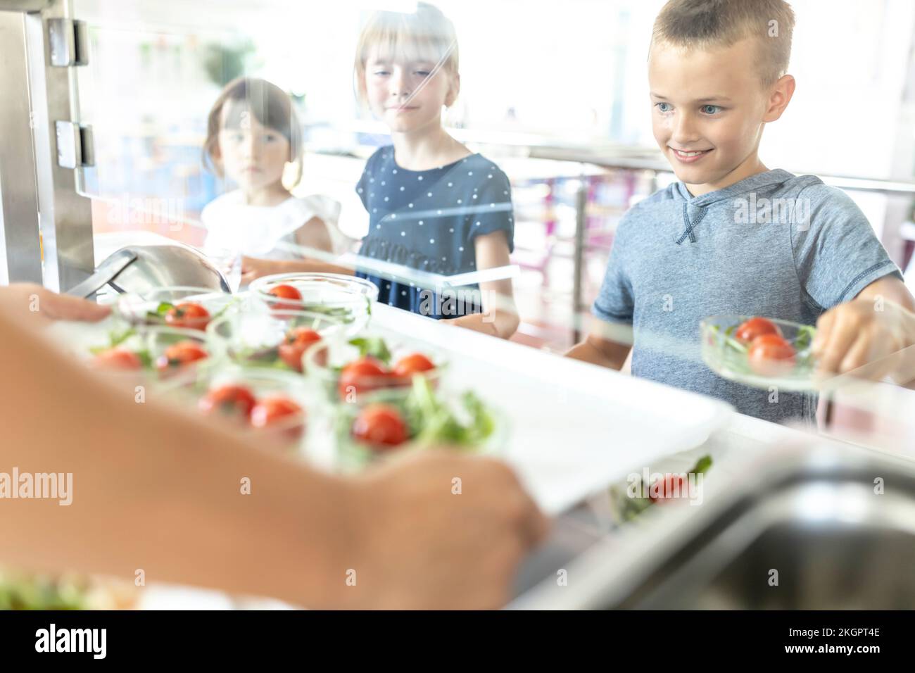 Students taking food standing in school cafeteria Stock Photo - Alamy