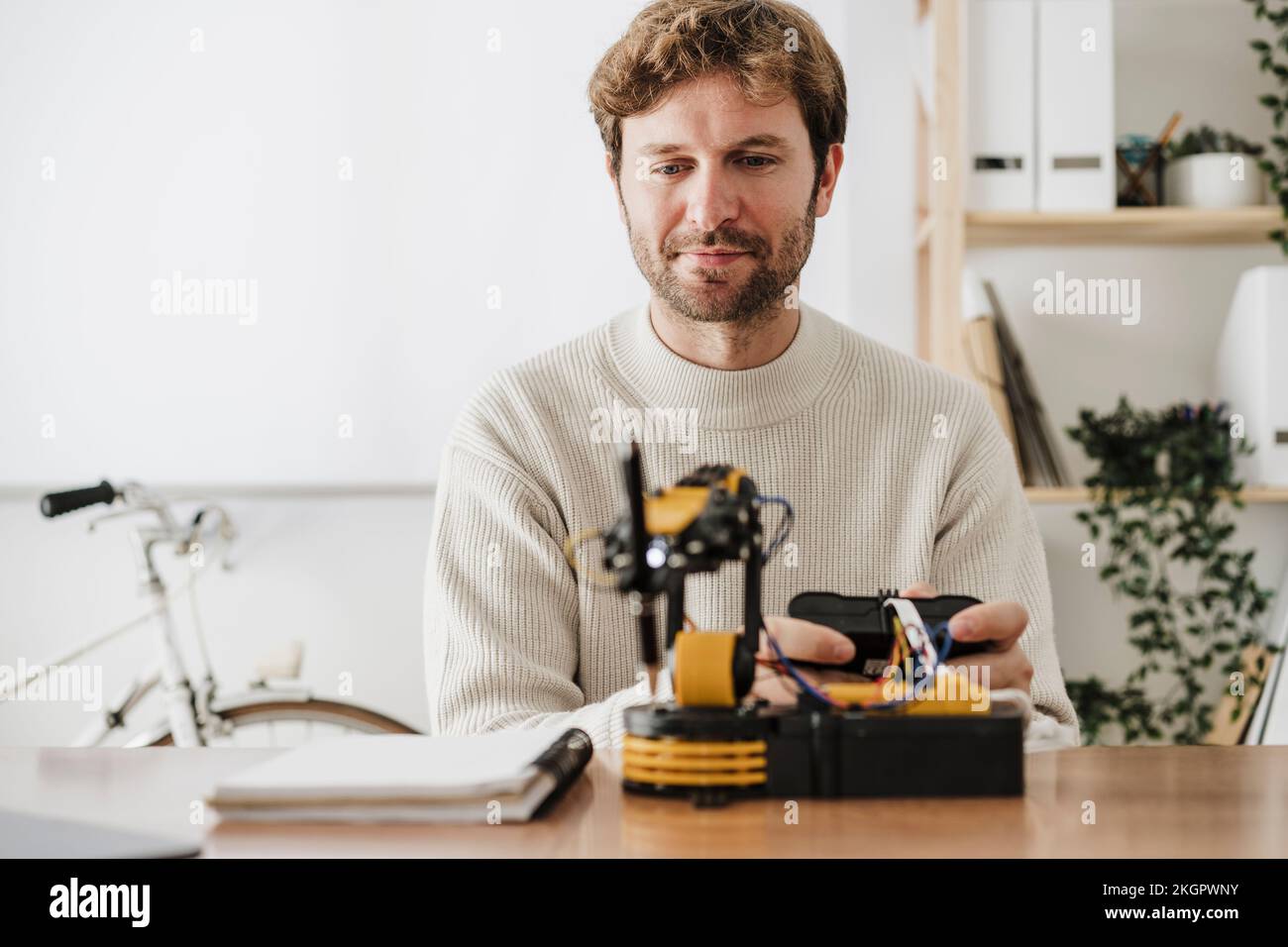 Engineer operating robotic model arm in office Stock Photo - Alamy Engineer operating robotic model arm in office Stock Photo - Alamy