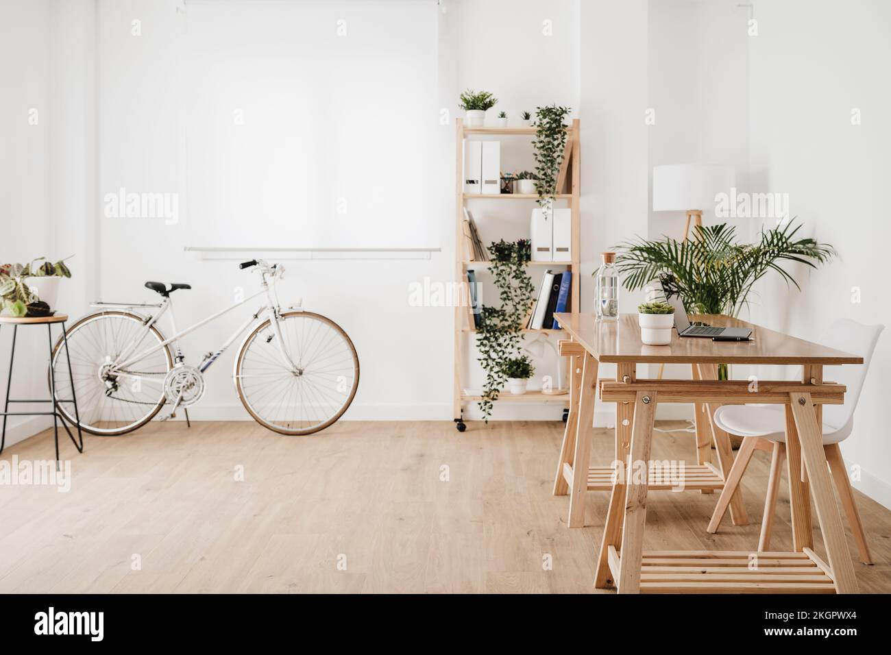Interior of modern office with bicycle and desk Stock Photo - Alamy
