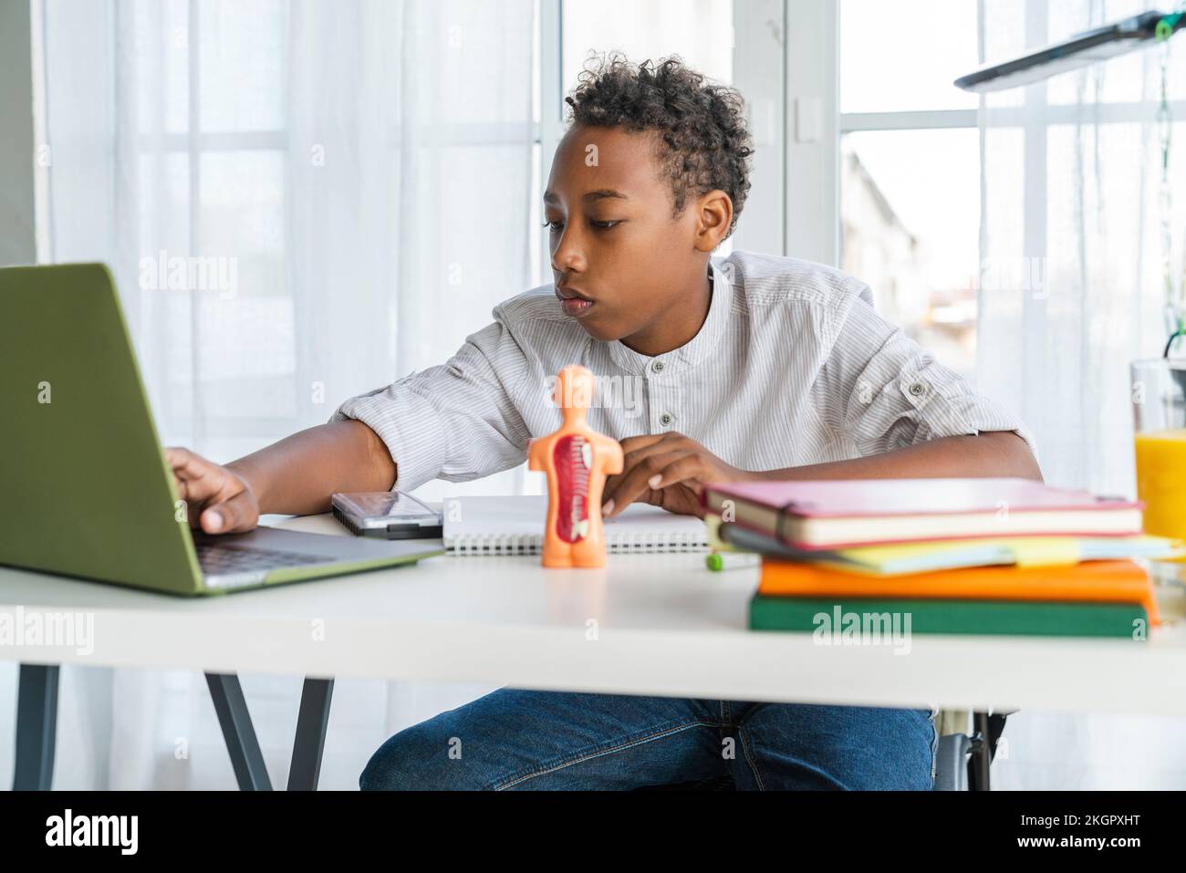 African boy sitting on table hi-res stock photography and images - Alamy