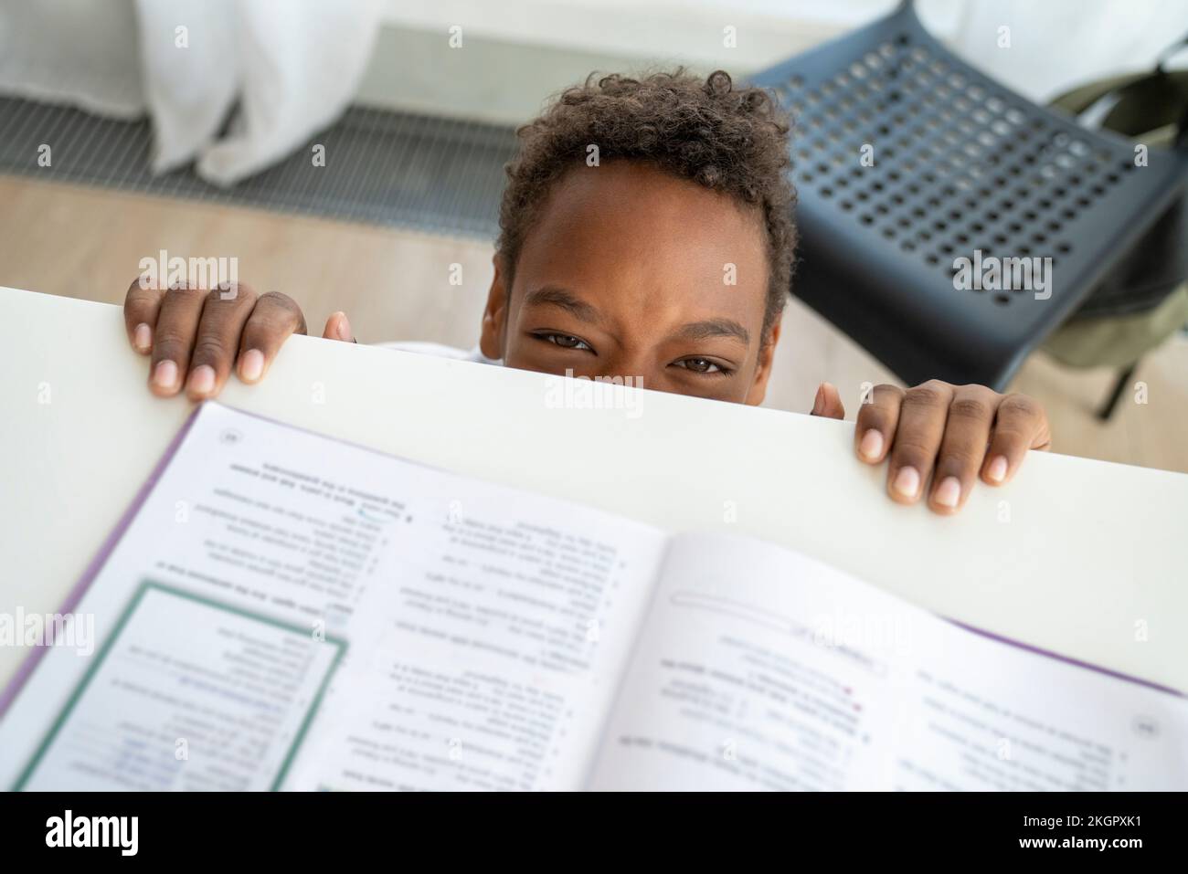 Boy peeking table hi-res stock photography and images - Alamy