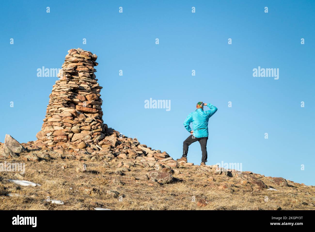hiker and large stone cairn overlooking Colorado prairie, Soapstone ...